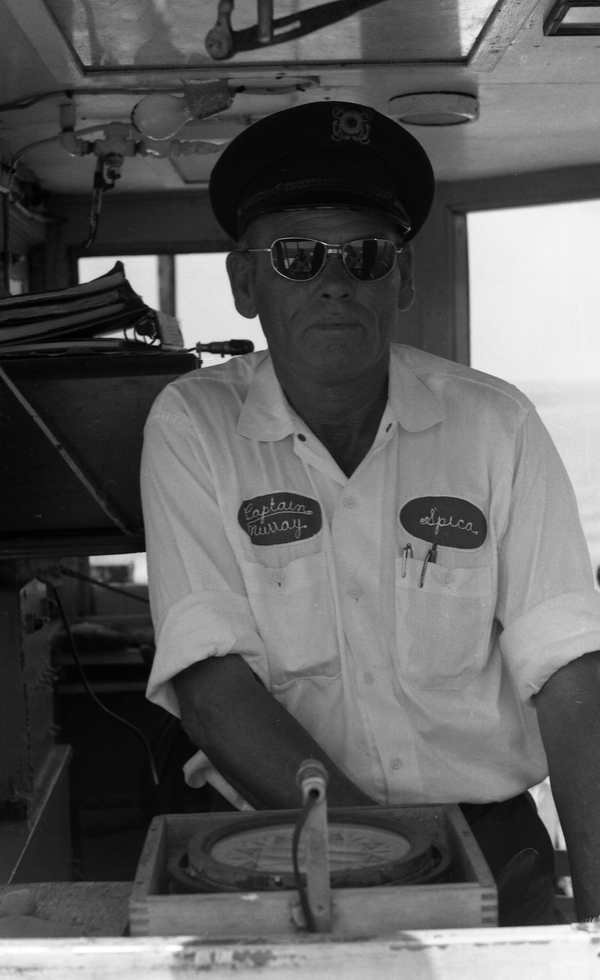Florida Memory • Captain Murray aboard the ferry "Spica" during trip to ...