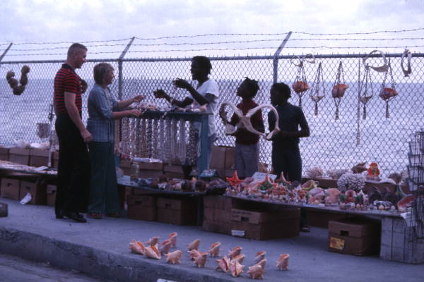 Florida Memory • Tourists buying shells from street vendors in Key West.