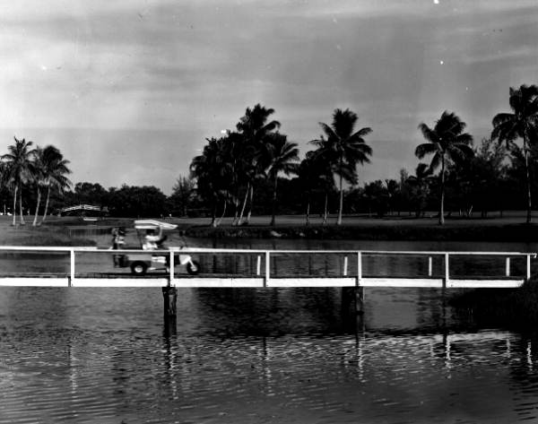 Florida Memory • Golfer crosses the bridge to the golf course - Coral ...