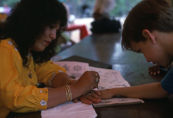 Florida Memory • Shalini Tandon drawing mehendi on visitor's hand at ...