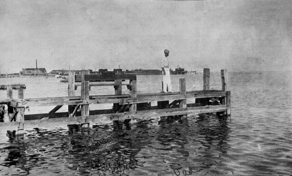 Florida Memory • Henry Gibbons fishing from a dock - Marathon, Florida