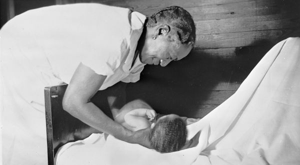 Florida Memory • Midwife holding just delivered baby