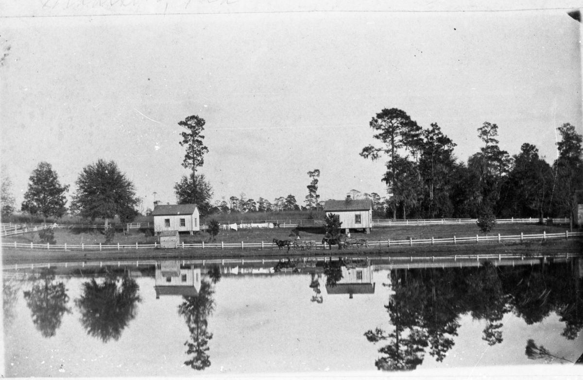 Florida Memory • Outbuildings of John L. Inglis home viewed across lake ...