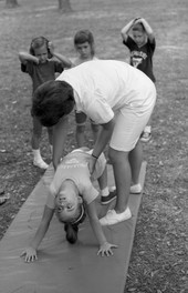 Florida Memory • Counselor giving child help during backbend at YMCA ...